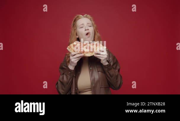 The beautiful hungry girl eating pepperoni pizza, enjoy and smile on ...