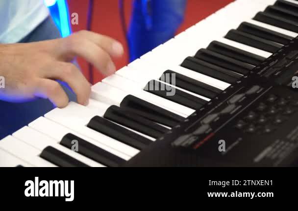 Electric piano, Actor playing on the keyboard synthesizer piano keys ...