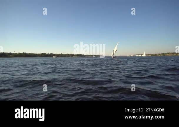 Cruising in Nile river Asawan Egypt on felucca boat deep blue water 4k ...