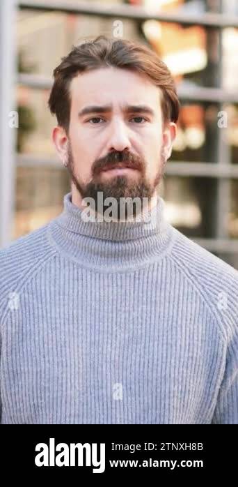 Vertical close up portrait of young caucasian man isolated outdoors ...