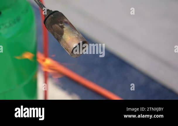 Process of melting a roll of tar onto the foundation of a house under ...