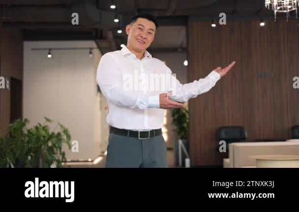 Male company owner of asian nationality inviting guests, foreign ...