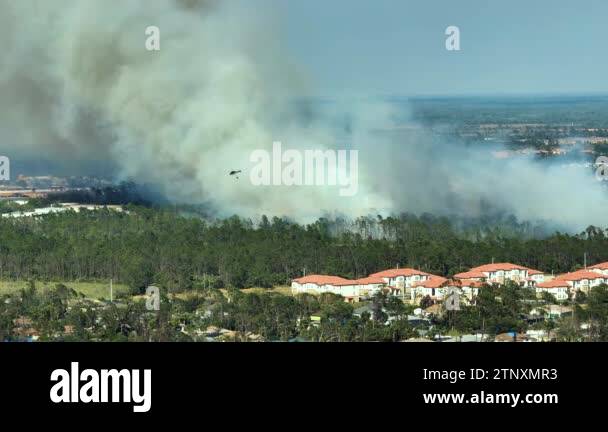 Fire department chopper extinguishing wildfire burning severely in ...
