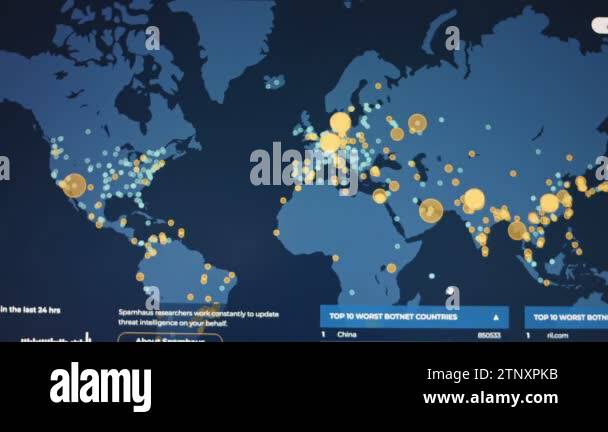 Criminal Hacker using computer pointing to a world map for organizing ...