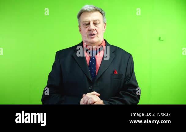 Senior newscaster journalist or speaker presenting news. Local newsreader speaks in TV studio ...