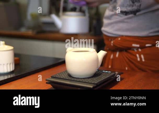 The hands of an indonesian tea artisan making tea fo custumer at his ...