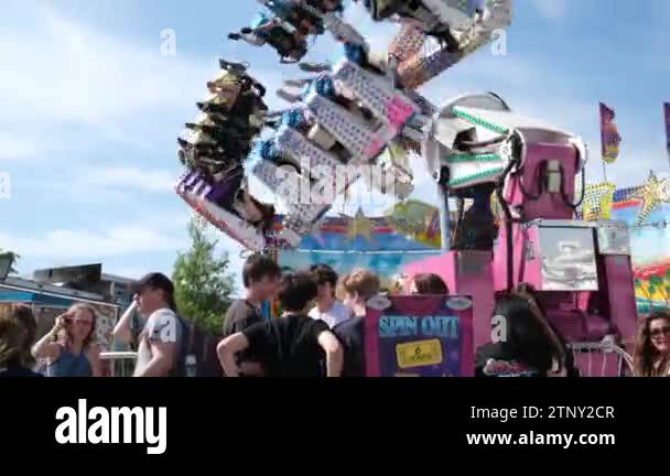 People riding on spinning swing carousel in amusement park Swing rides ...