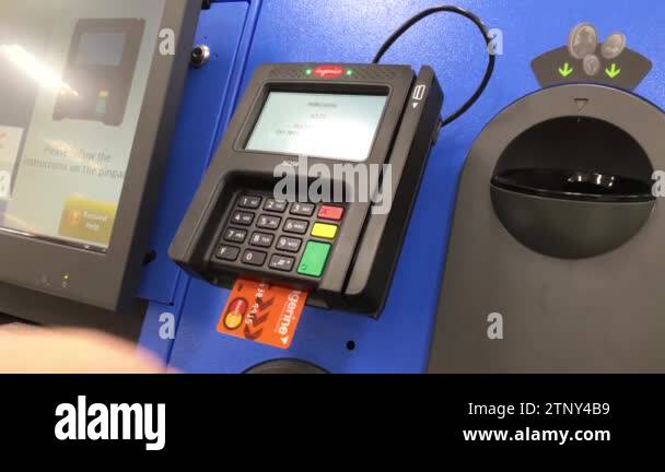 The motion of a man paying credit card for food at the self-checkout ...