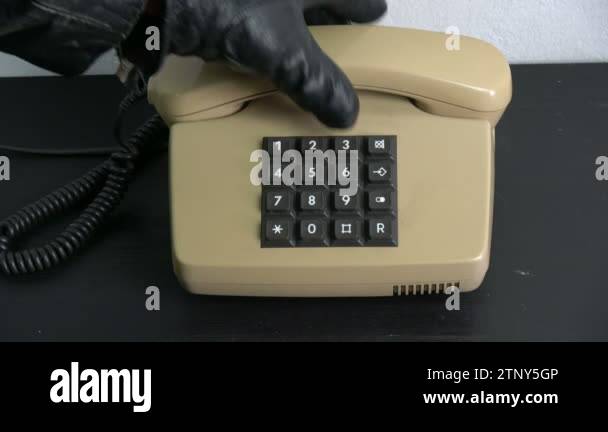Robber gangster hand with black leather glove pressing numbers on retro ...