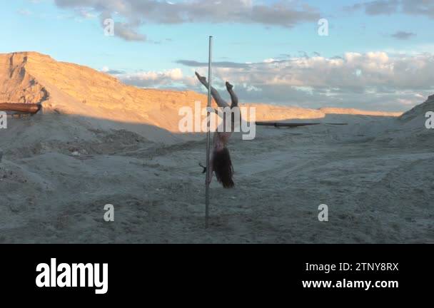 Woman trains to dance on a pole, she is an artist Stock Video Footage ...