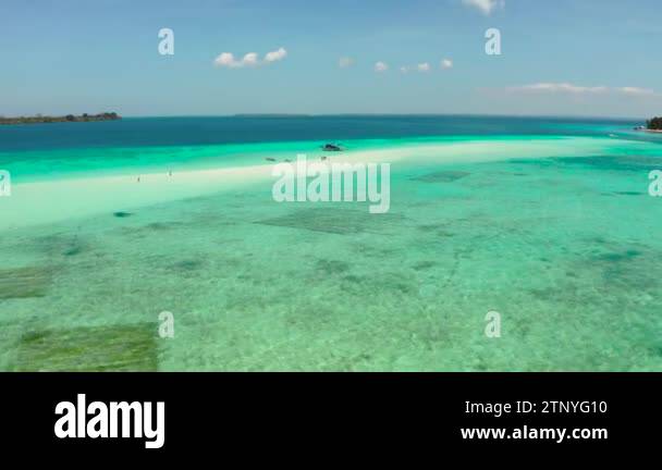 White sandy beach in the lagoon with turquoise water on a tropical ...