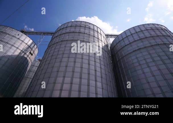 Modern grain elevator terminal in sea port. Metal tanks and conveyors ...