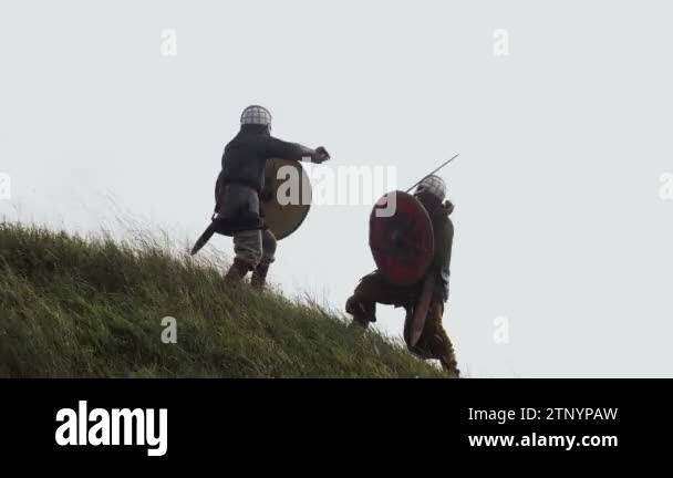 Two warriors Viking are fighting with swords and shields Stock Video ...