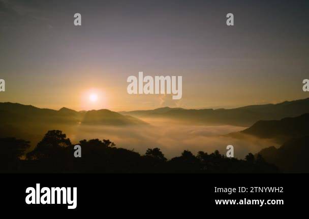 The orange-red glow of the sunrise illuminated the raging sea of clouds ...