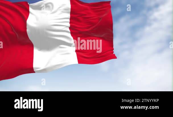 Peru national flag waving on a clear day. Vertical tri-band consisting ...