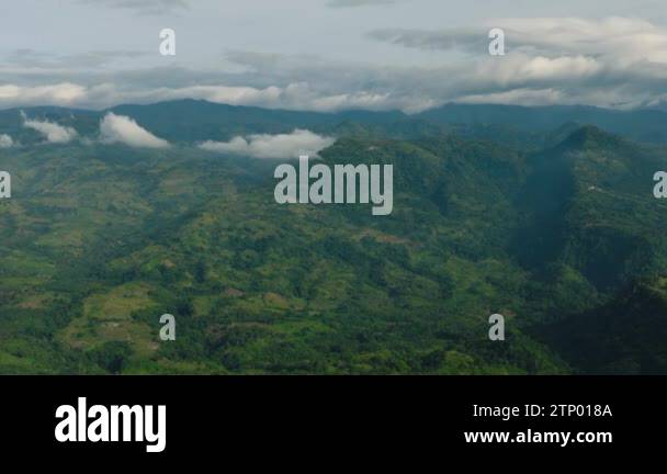 Tropical mountain range and mountain slopes with rainforest. Blue sky ...