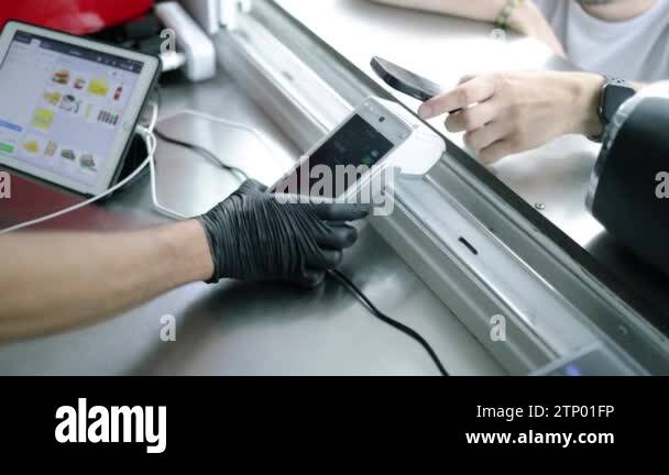 Man using smartphone cashless wallet NFC technology to pay for order on ...