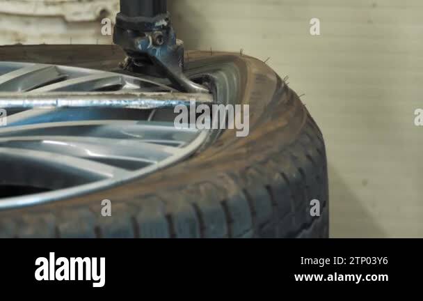 Tyre Fitting. Mechanic using hydraulic or mechanical press to remove ...
