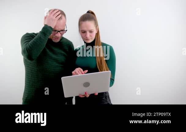error in work man adult in horror clutching his head young girl calmly ...