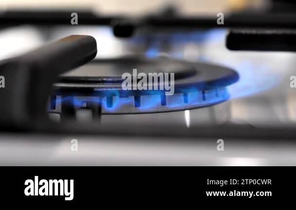 Turning on and off hob of gas stove. Close-up of flame during operation ...