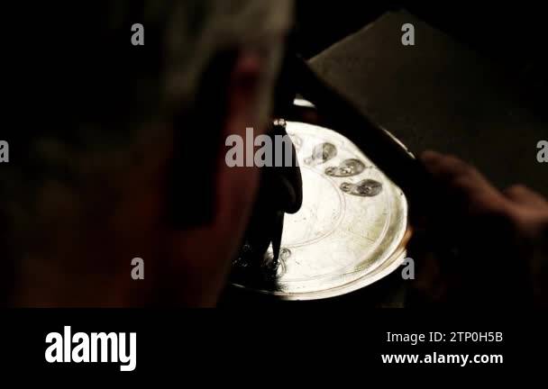Traditional tinsmith work. Copper smith makes embossing artifacts from ...
