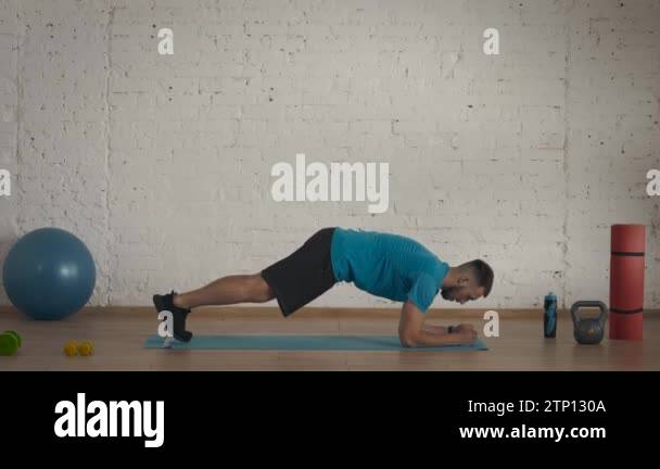 Personal sport trainings at home. Athletic male fitness coach doing ...