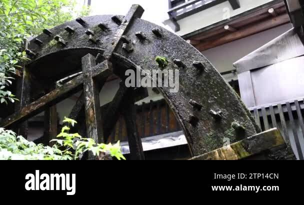 A historic wooden wheel on the water surface in Tokyo. High quality 4k ...