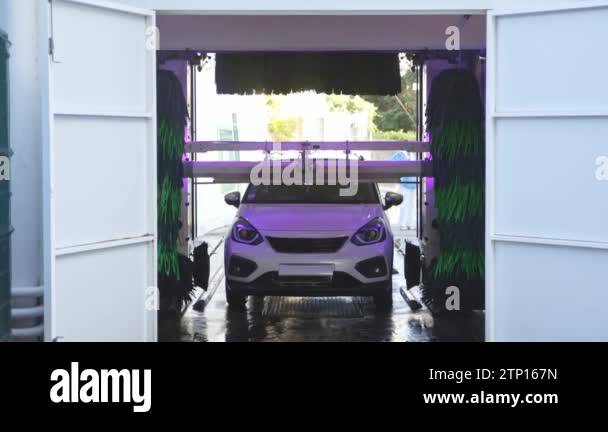 A white car without license plates in an automatic car wash - the ...