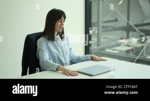 Woman office worker closes her laptop with a sense of accomplishment ...