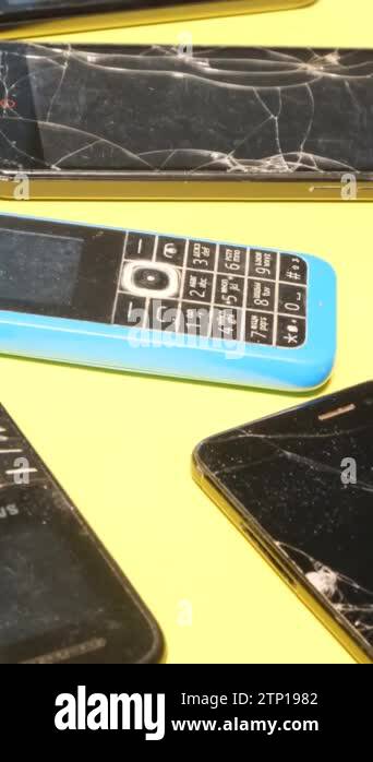 Cracked mobile phones with a cracked screen. Recycling of mobile phones ...