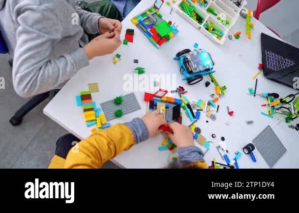 Robotics programming class. Children construct and code Robot. STEM education using constructor ...