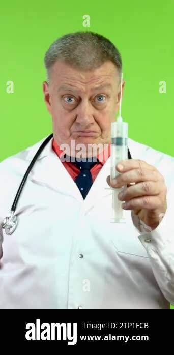 Senior angry doctor physician threatens his index finger and big ...