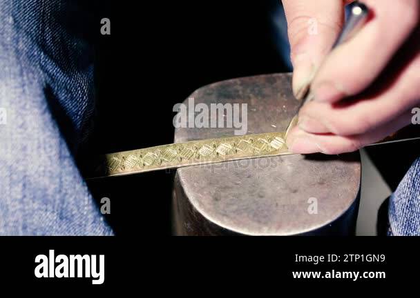 Traditional tinsmith work. Copper smith makes embossing artifacts from ...