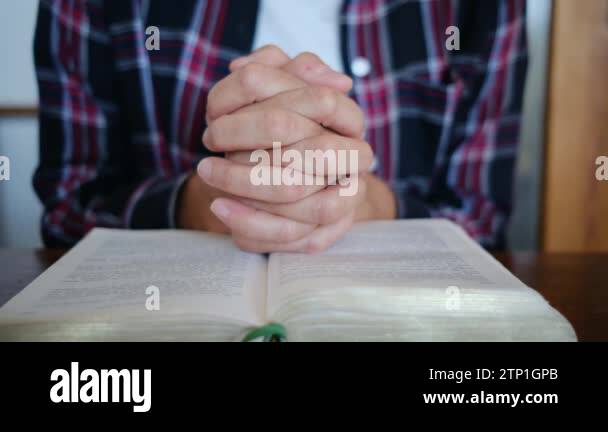 A woman's devout Bible reading and prayer epitomize faith in God and ...