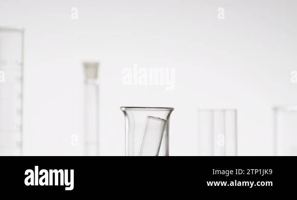 Video of glass laboratory test tube with pink liquid in beaker with ...