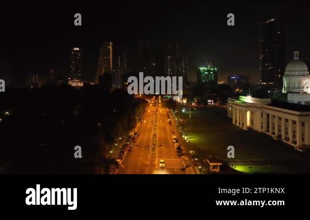 Forwards fly above multilane street at city hall. Night city scene with ...