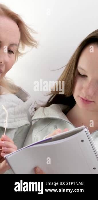 mom and daughter doing homework, woman wearing glasses, young teenage ...