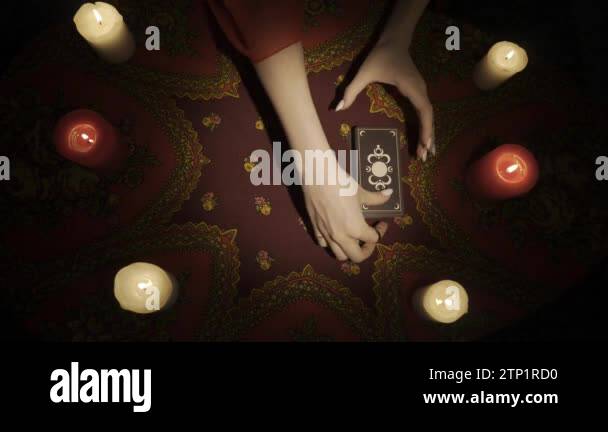Fortune teller session scene, top view. Close up shot of a female hands ...