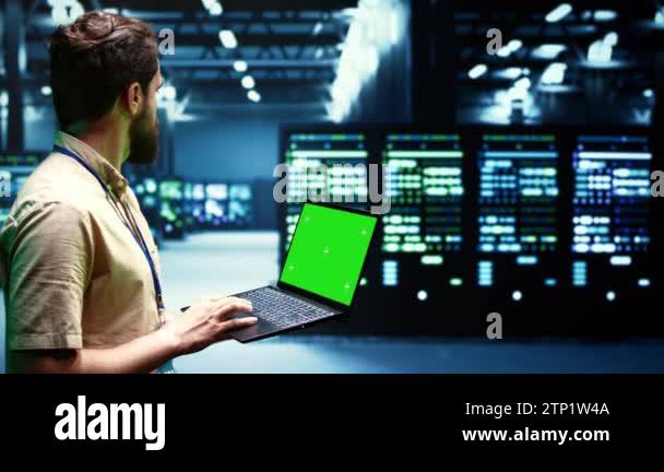 Expert using chroma key laptop to check server hub configuration settings, close up. Mechanic ...