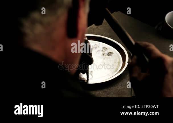 Traditional tinsmith work. Copper smith makes embossing artifacts from ...