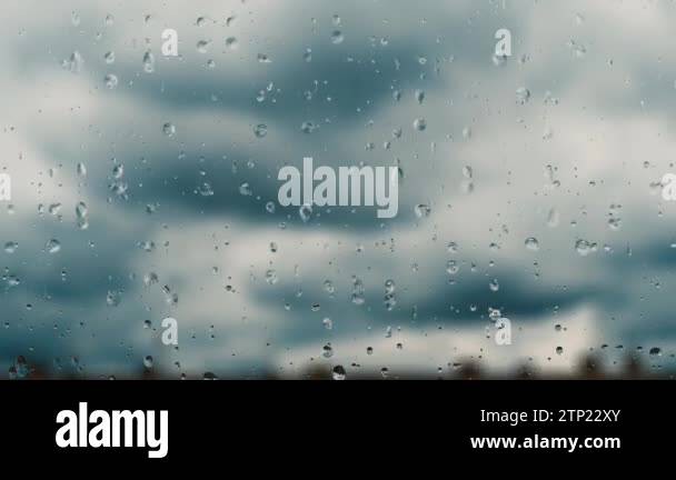 Rainy cloudy day outside the window. Foggy window glass with drops of ...
