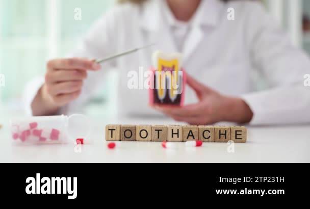 Dentist is working on dental implant and writing prescription for ...