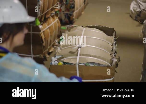Shooting over shoulder of blurred woman pushing pushcart with packed ...