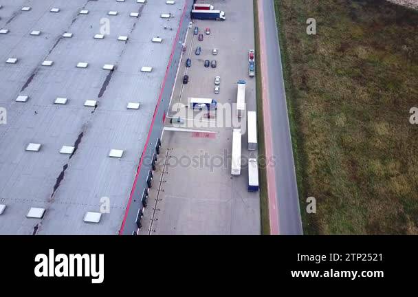 Trucks are Driving to Logistics Center. Aerial Shot./ Storage Building ...