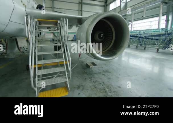 Aircraft engine in the hangar. Airplane turbine detail, plane in hangar ...