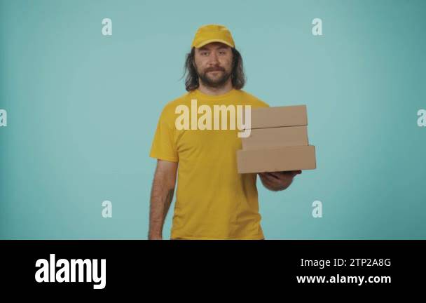 Courier service concept. Portrait of a delivery man in yellow cap ...