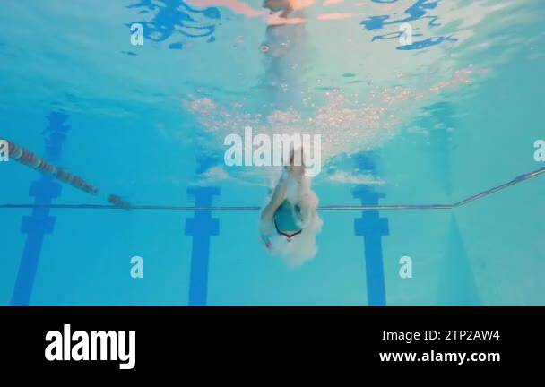 Woman athlete swims underwater in the pool. Slow motion of a female ...