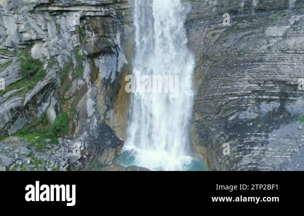 Clean water splashing and falling from rough cliff in daytime in ...