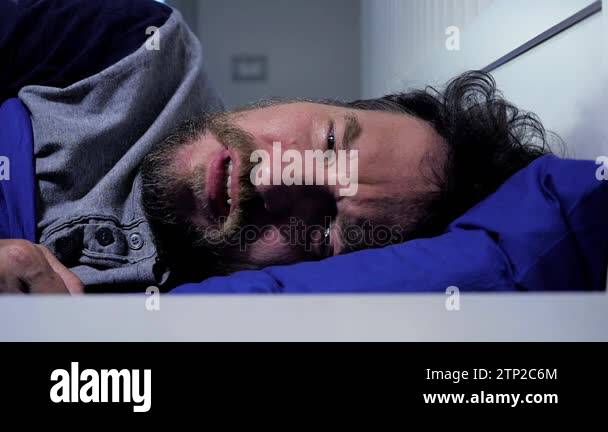 Sad man crying in bed slow motion Stock Video Footage - Alamy