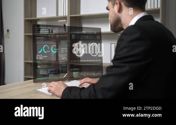 Businessman analyzes data on futuristic computer with transparent display. Device shows a ...